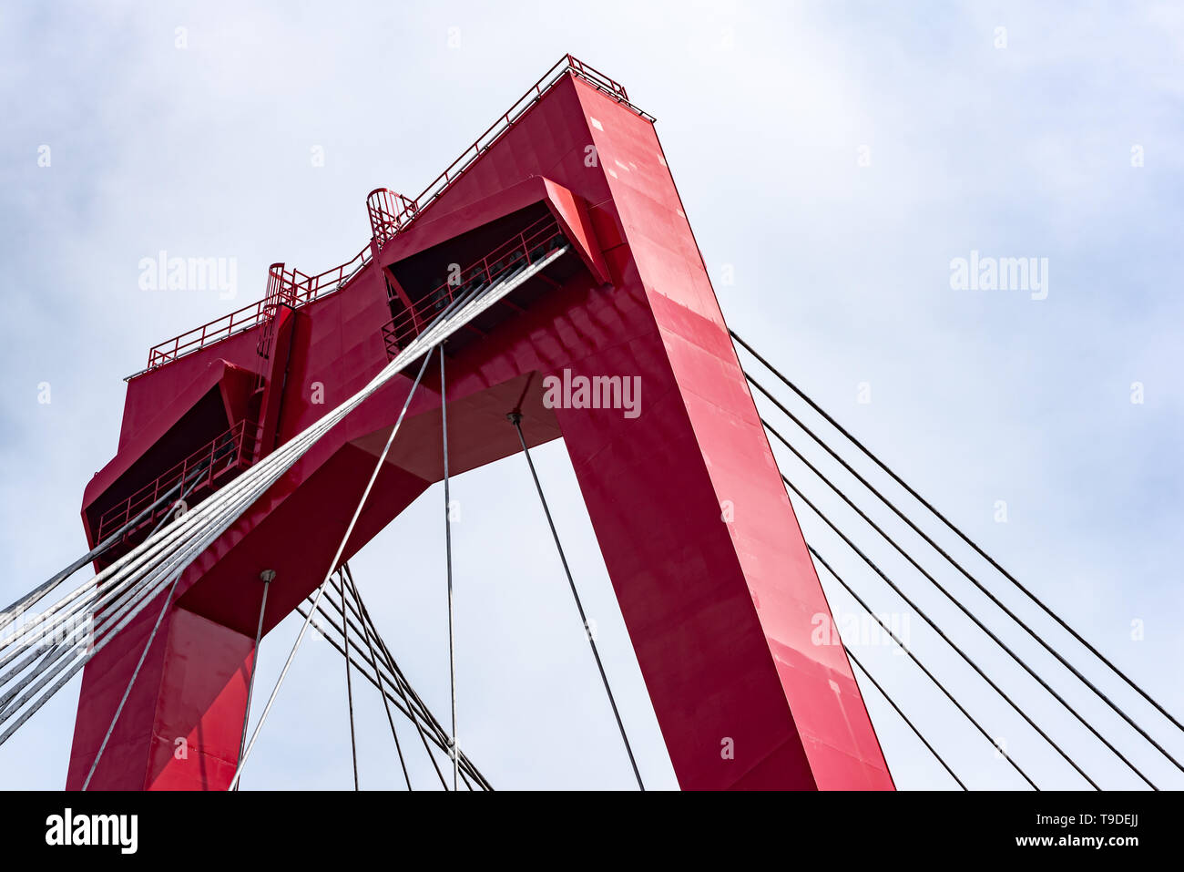 Willemsbrug bridge red cable bridge against blue sky and white clouds ...