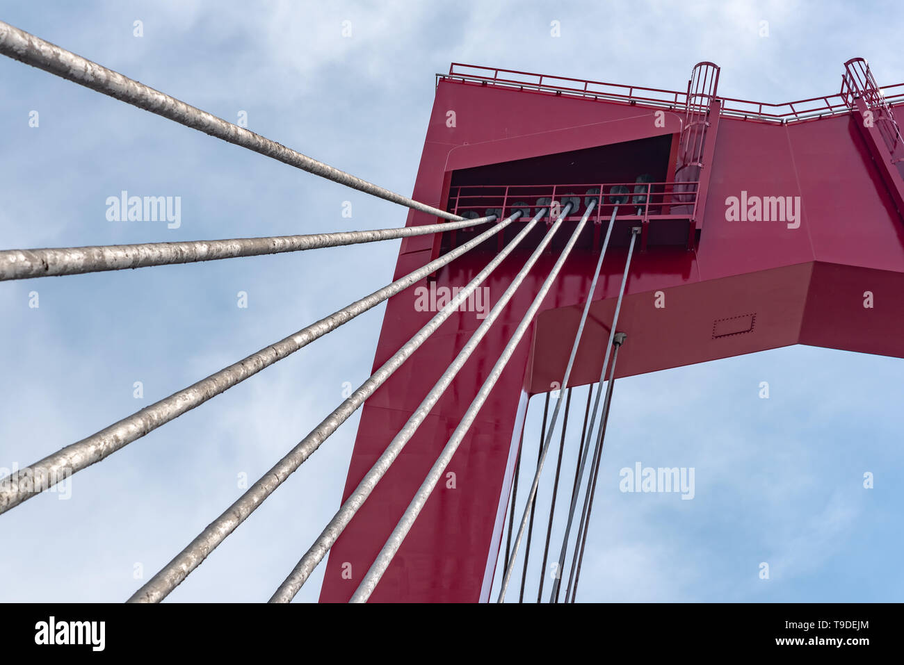 Willemsbrug bridge red cable bridge against blue sky and white clouds ...