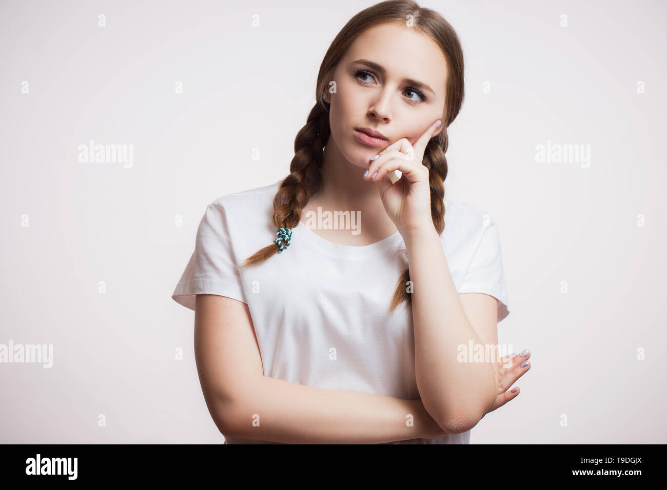 Close up portrait of beautiful young woman thinking and looking upwards ...