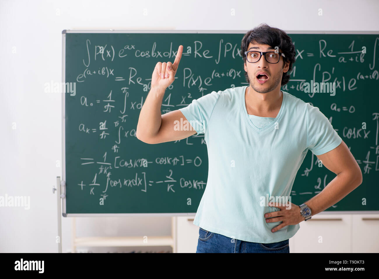 Young male student mathematician in front of chalkboard Stock Photo - Alamy
