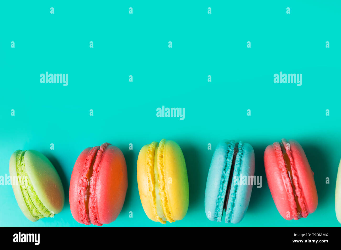 Beautiful fresh macaroon on turquoise background with copy space Stock ...