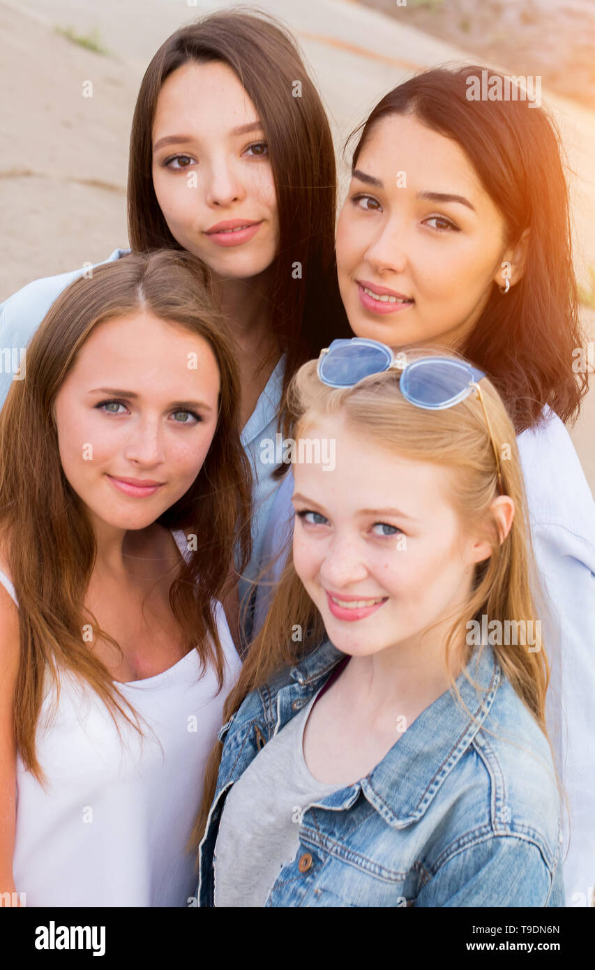 portrait of four femle friends looking friendly at camera, smile, happy ...