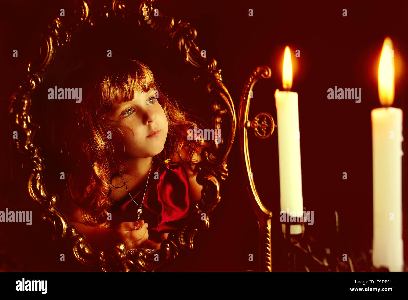 Reflection of the beautiful little girl in the mirror, with cand Stock ...