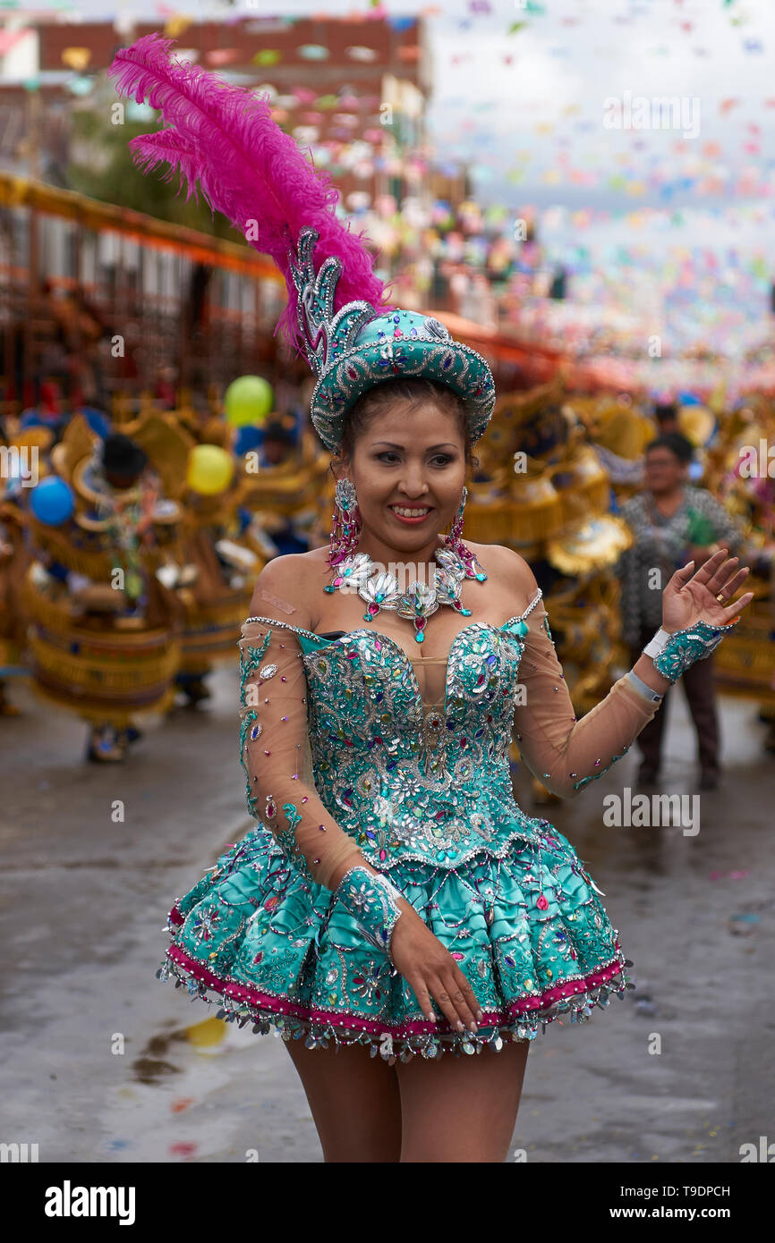 Morenada dancers in ornate costumes parading through the mining city of ...