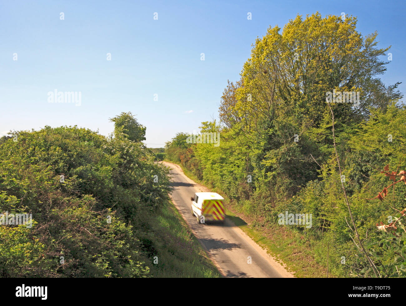 A narrow minor country road with travelling van in the Norfolk ...
