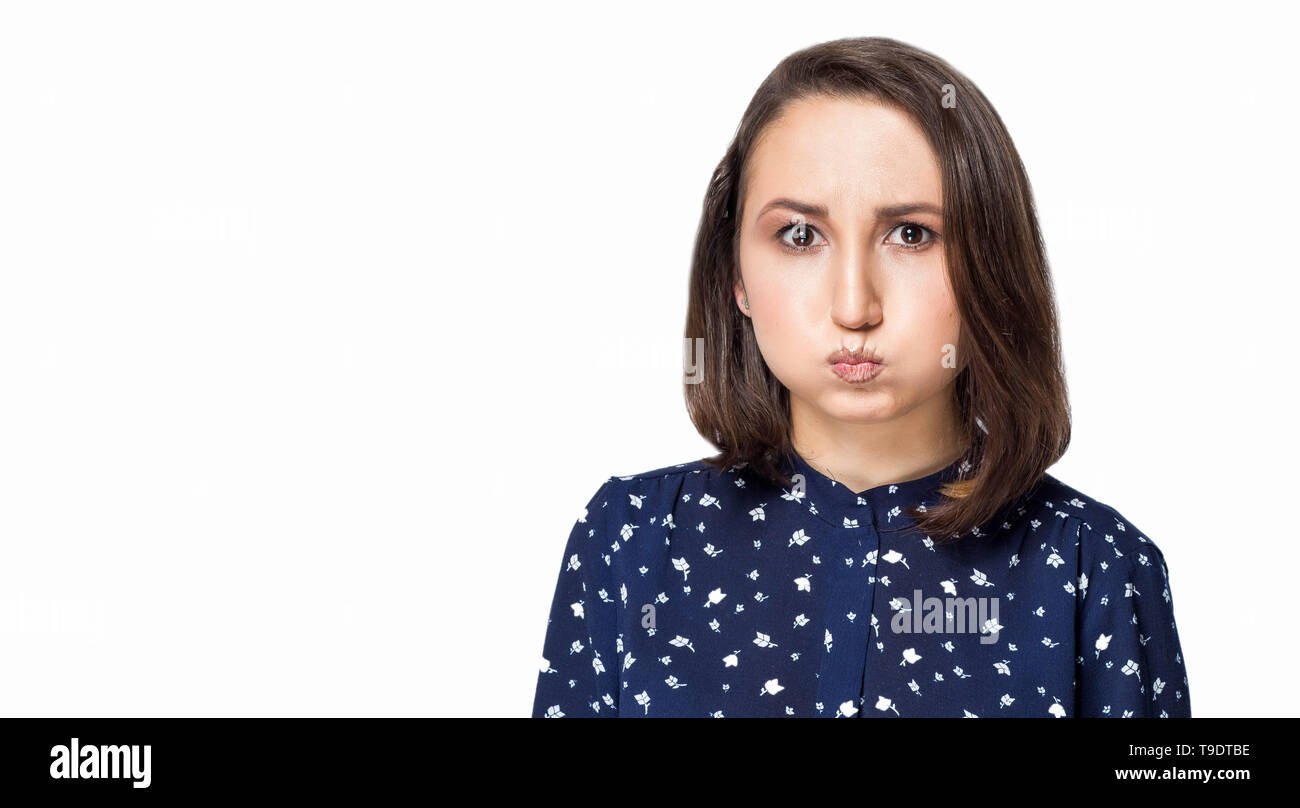 Funny pretty girl puffing out her cheeks on white isolate background ...