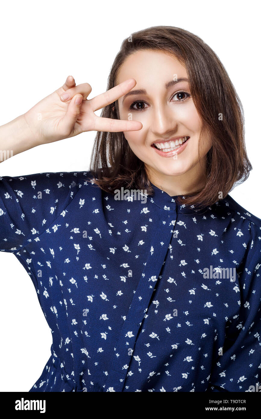 beautiful girl with a smile looking at the camera with hand with two ...