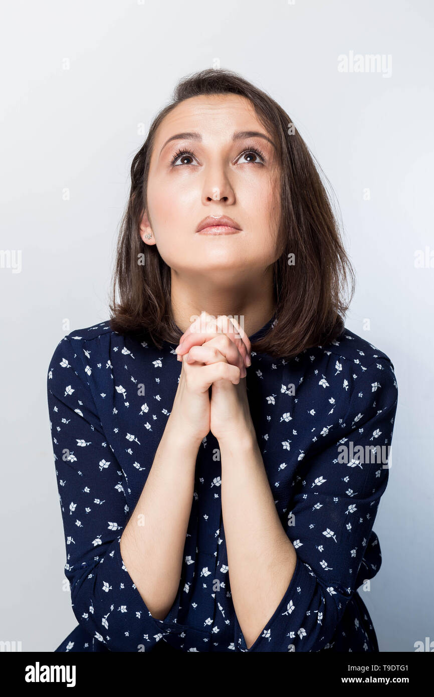 Beautiful woman praying, looking up with a request Stock Photo - Alamy
