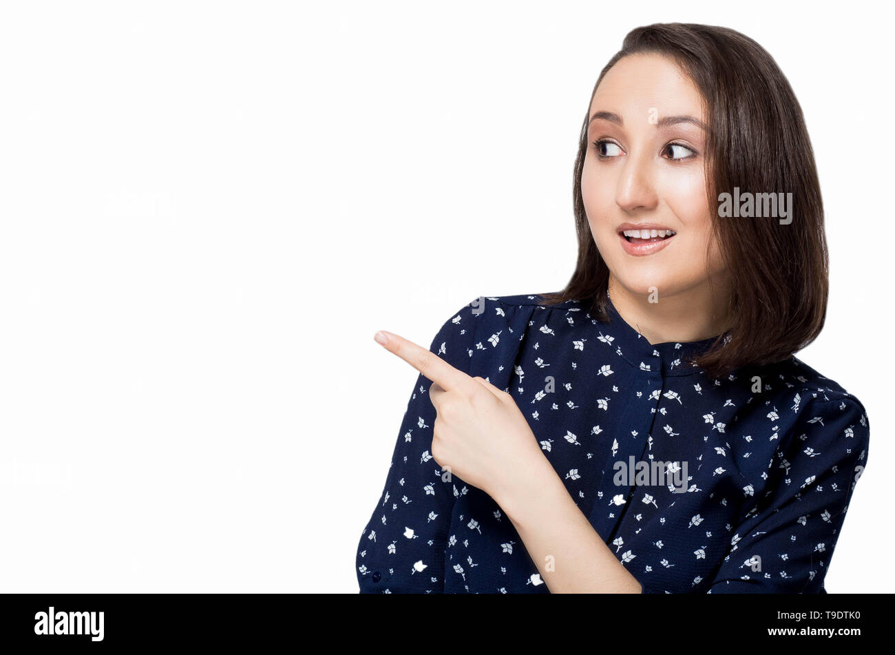 Happy charming young woman showing one finger and pointing up over ...