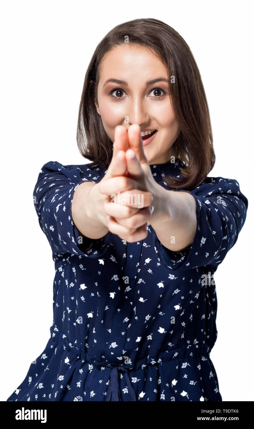 Pretty young happy smiling girl making gun gesture and pointing at ...