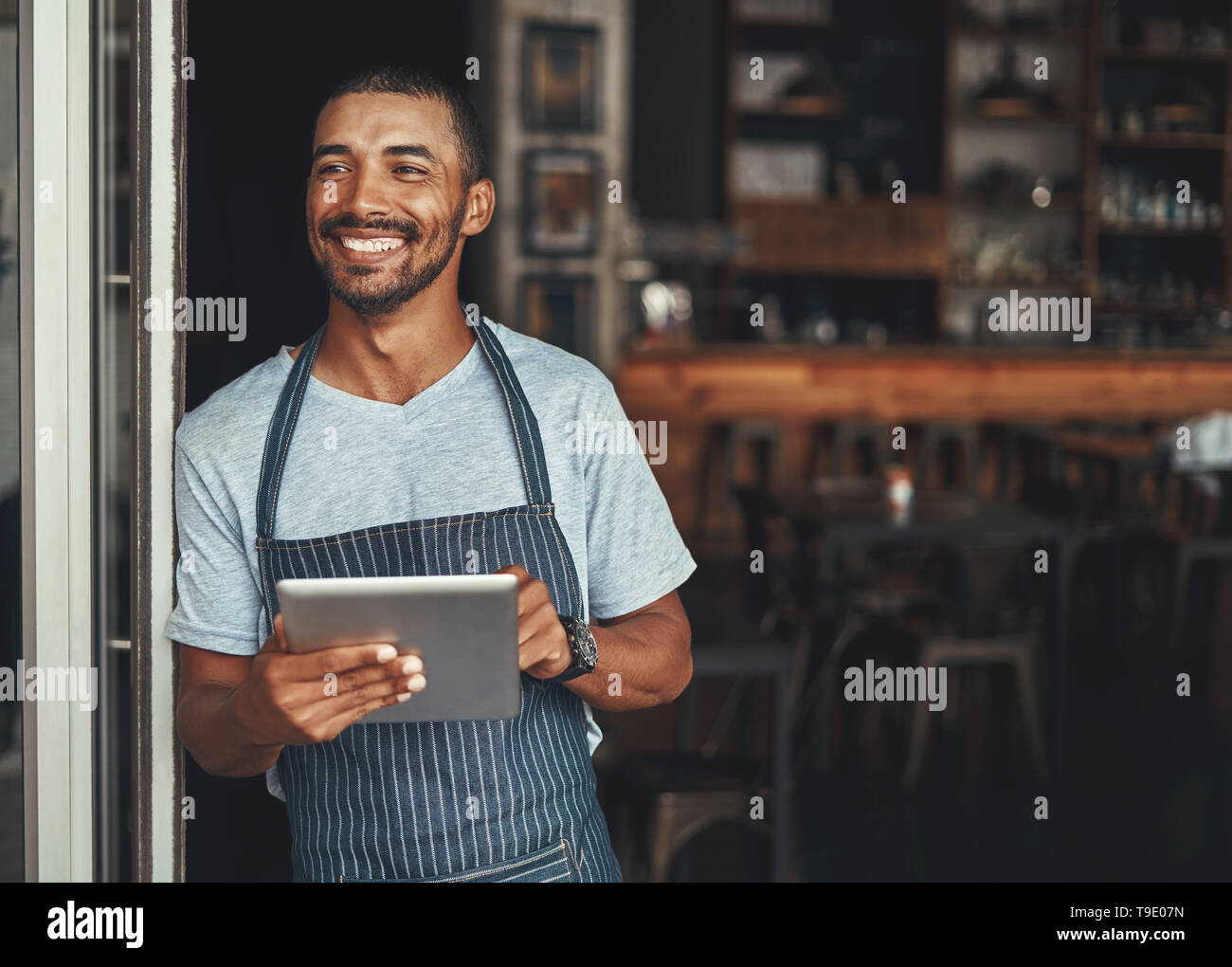 Male owner standing cafe entrance hi-res stock photography and images ...