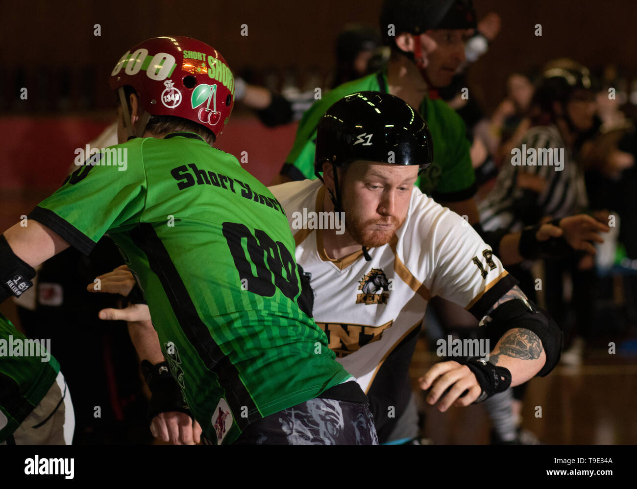 Two roller derby skaters blocking each other Stock Photo - Alamy