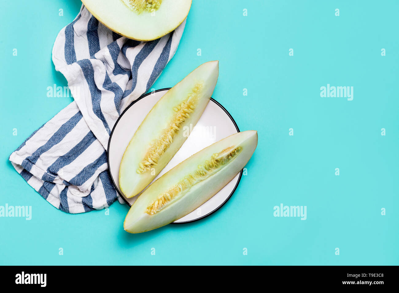 Minimum flat lay of fresh melons sliced on a pastel blue background ...
