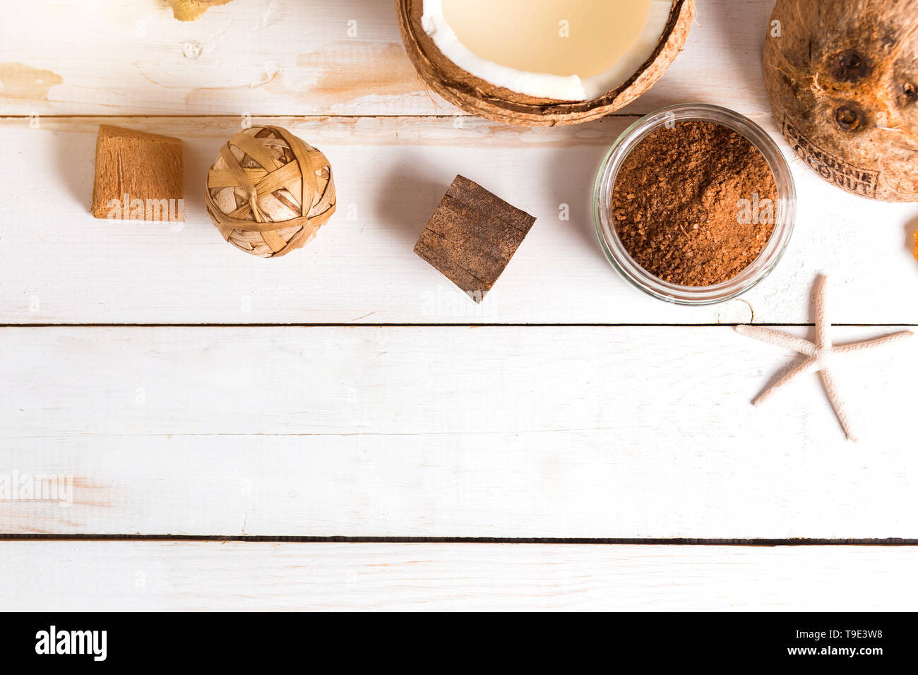 Flat lay composition with coconut, seashell, homemade scrub with coffee ...