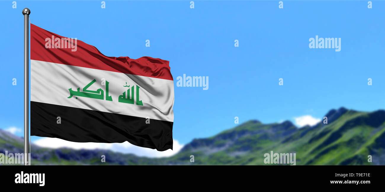 Iraq flag waving in the blue sky with green fields at mountain peak ...