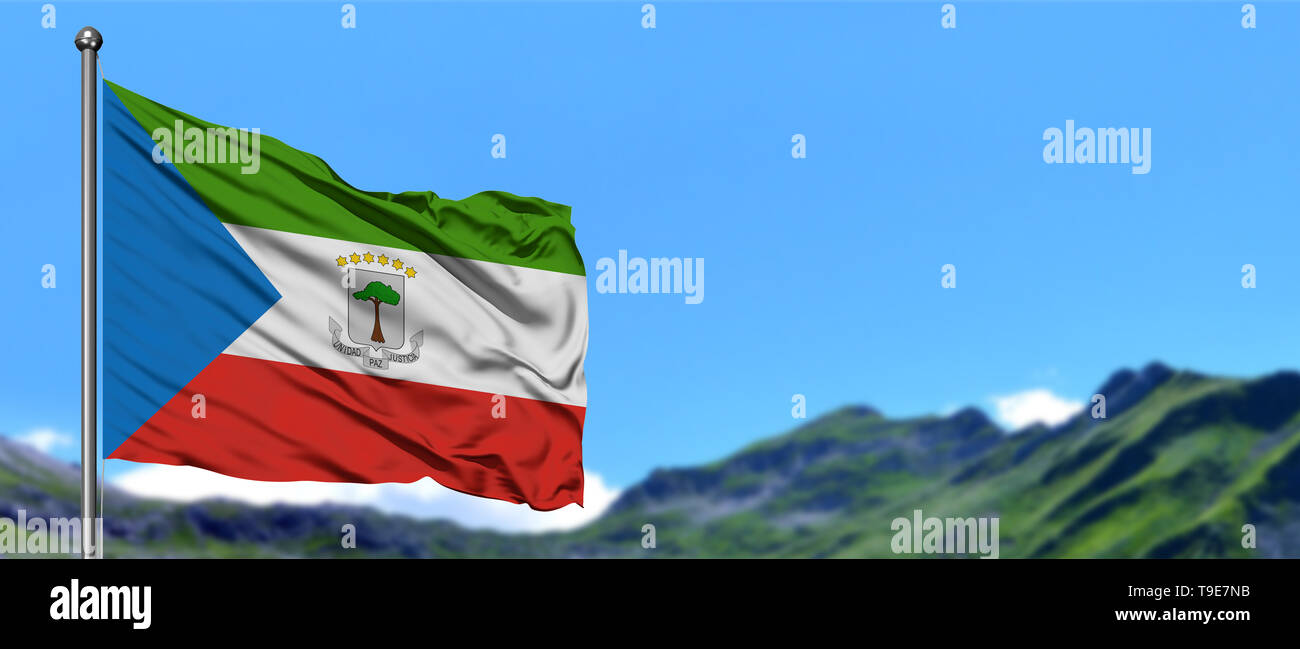 Equatorial Guinea flag waving in the blue sky with green fields at ...