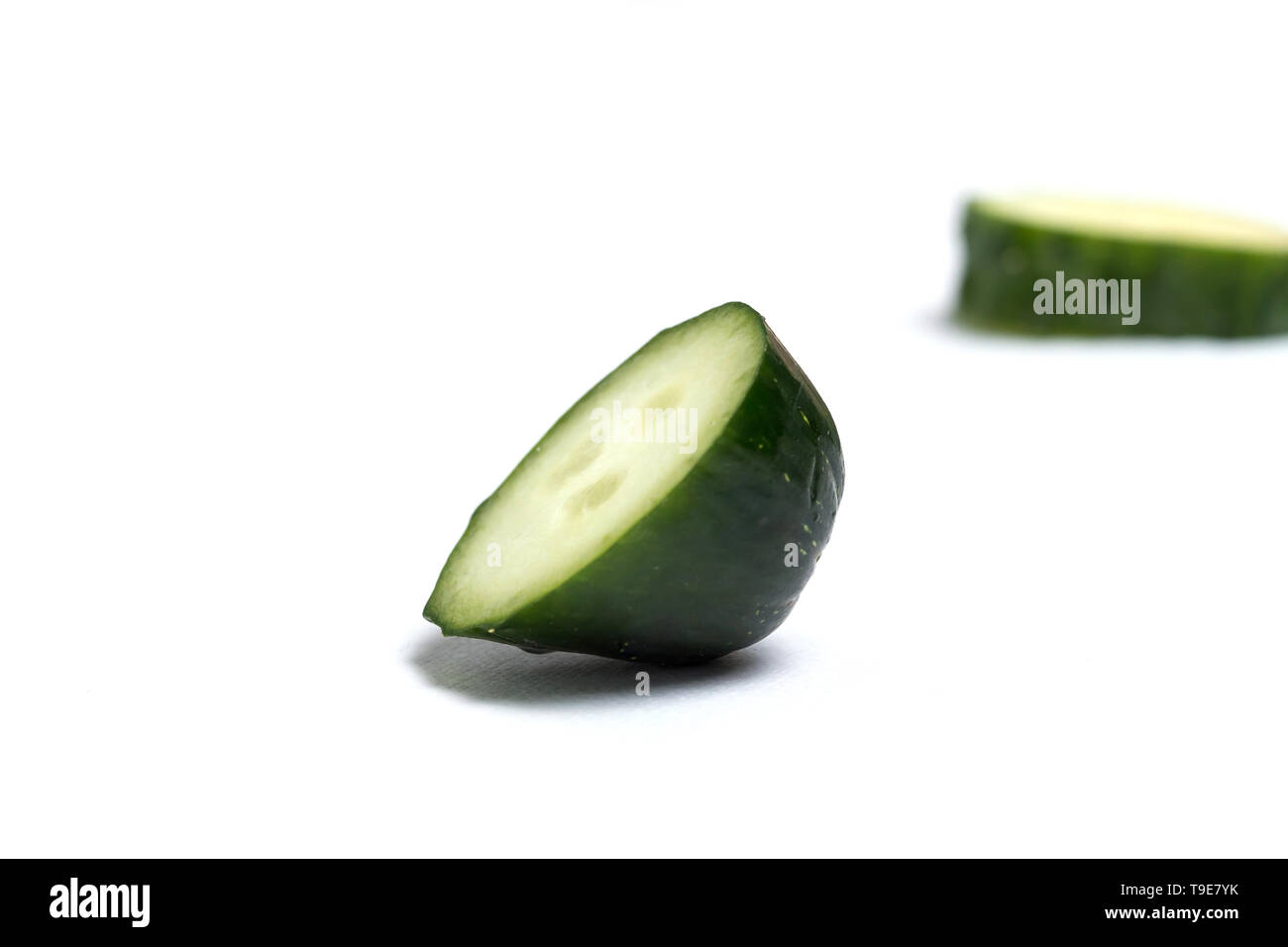 cucumber pieces isolated on a white background Stock Photo - Alamy