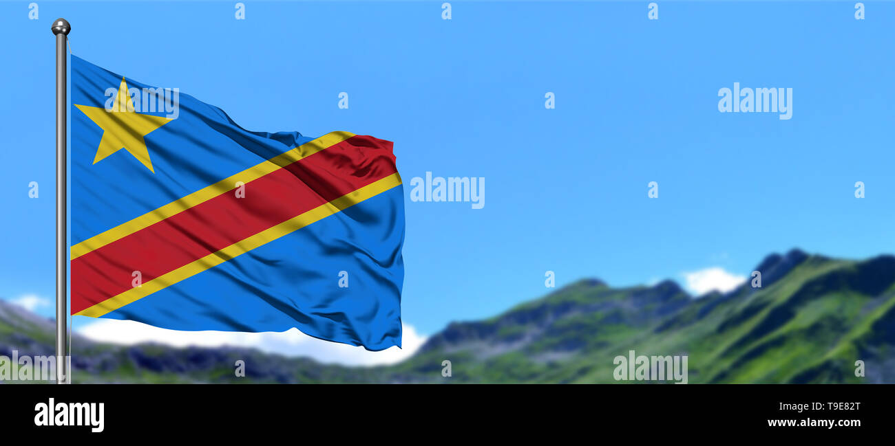 Congo flag waving in the blue sky with green fields at mountain peak ...