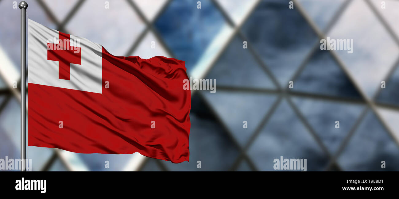 Tonga flag waving in the wind against blurred modern building. Business ...