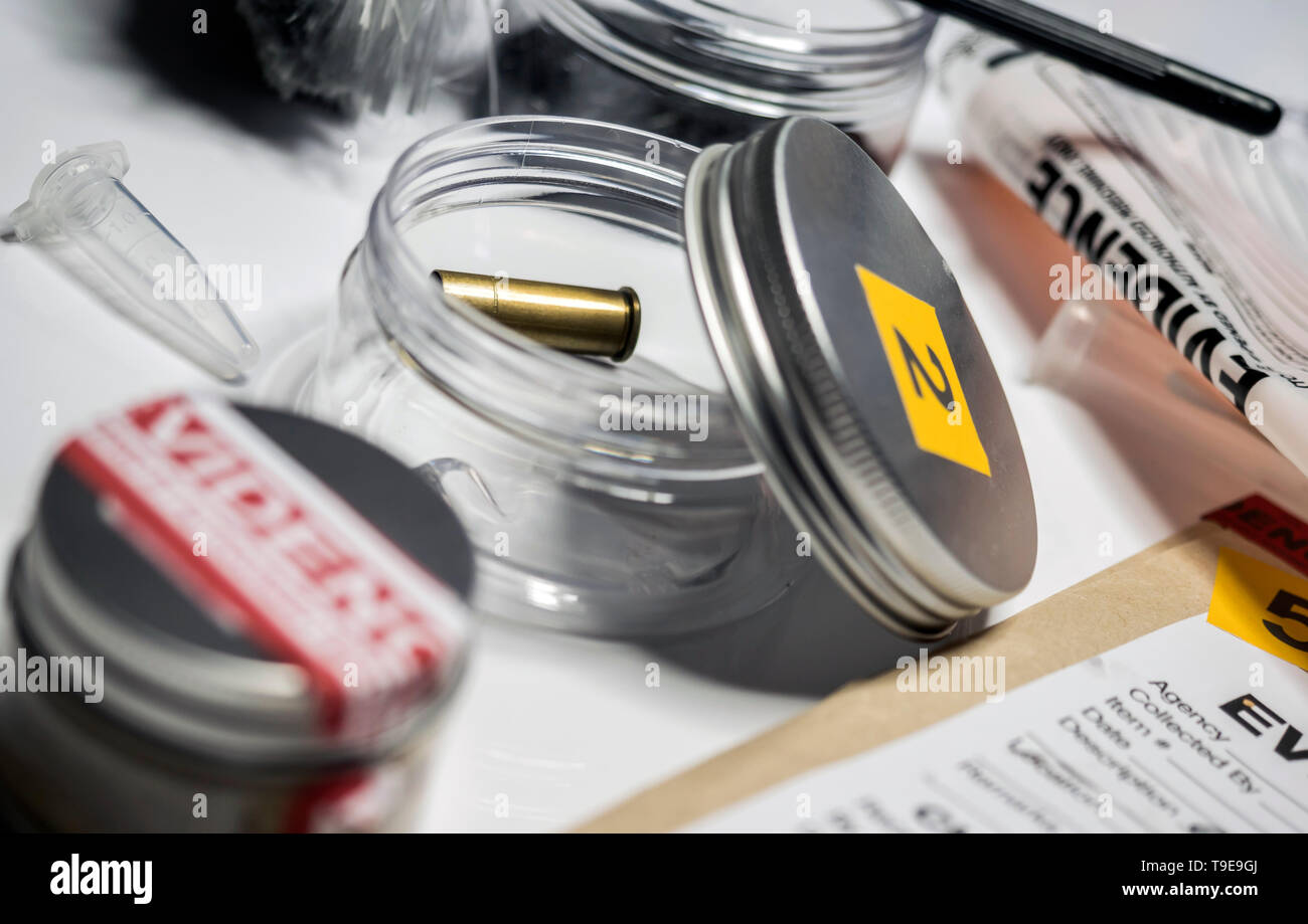Evidence of crime scene, bullet cap in laboratory scientist, conceptual ...