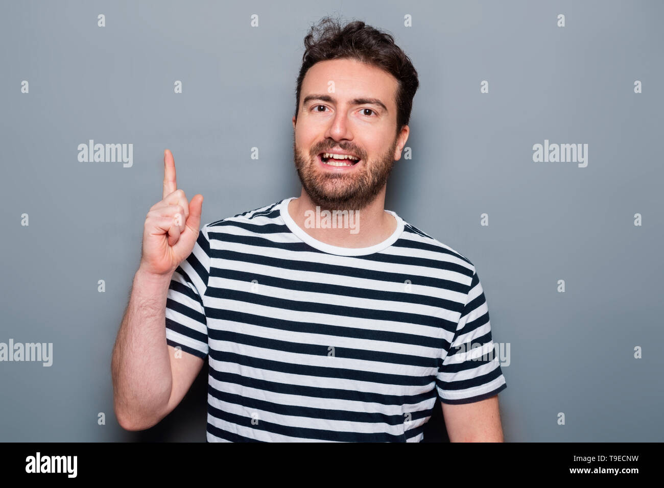 Handsome guy pointing finger up hi-res stock photography and images - Alamy