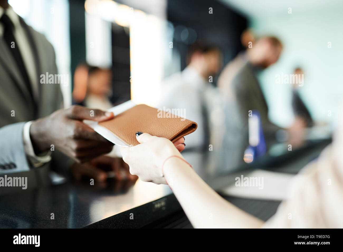 Giving back passport Stock Photo - Alamy