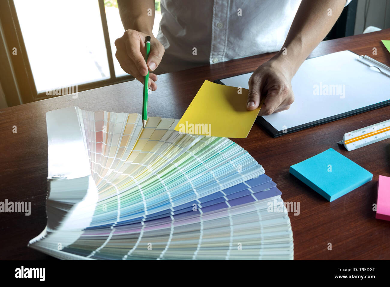 Graphic designer choose colors from the color bands samples for design ...