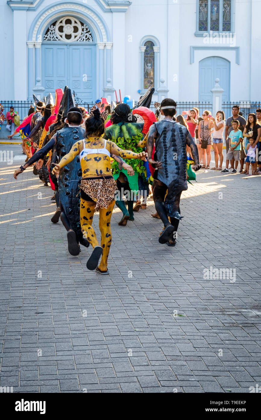 People in disguise dance and celebrate their traditions on the parade ...