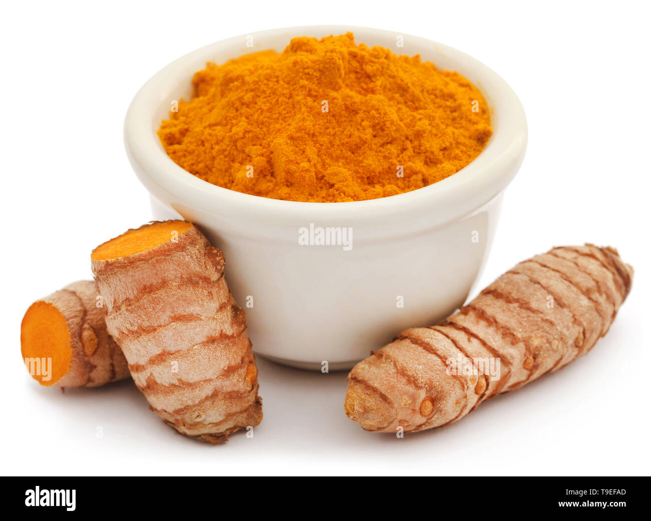 Raw turmeric with powder over white background Stock Photo - Alamy