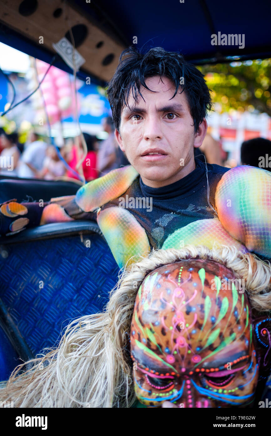 People in disguise dance and celebrate their traditions on the parade ...