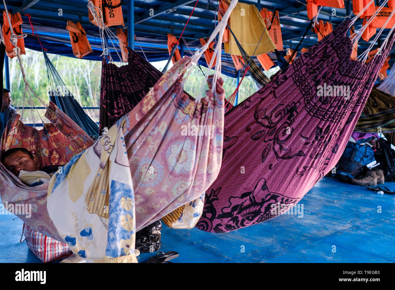 Hammocks for passengers set on the deck of the lancha or ferry that ...