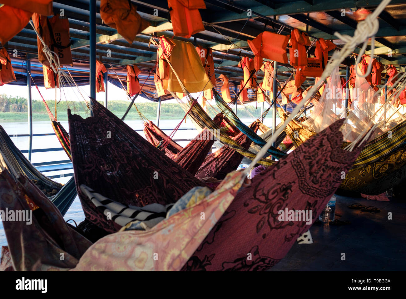 Hammocks for passengers set on the deck of the lancha or ferry that ...