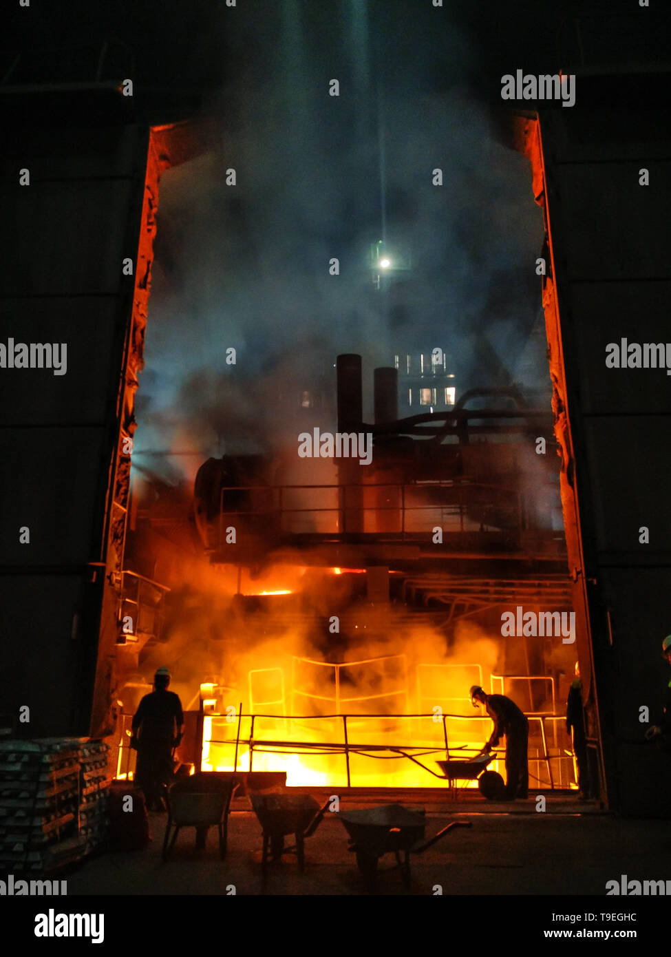 Smelting of metal in big foundry. Iron and steel production at a ...