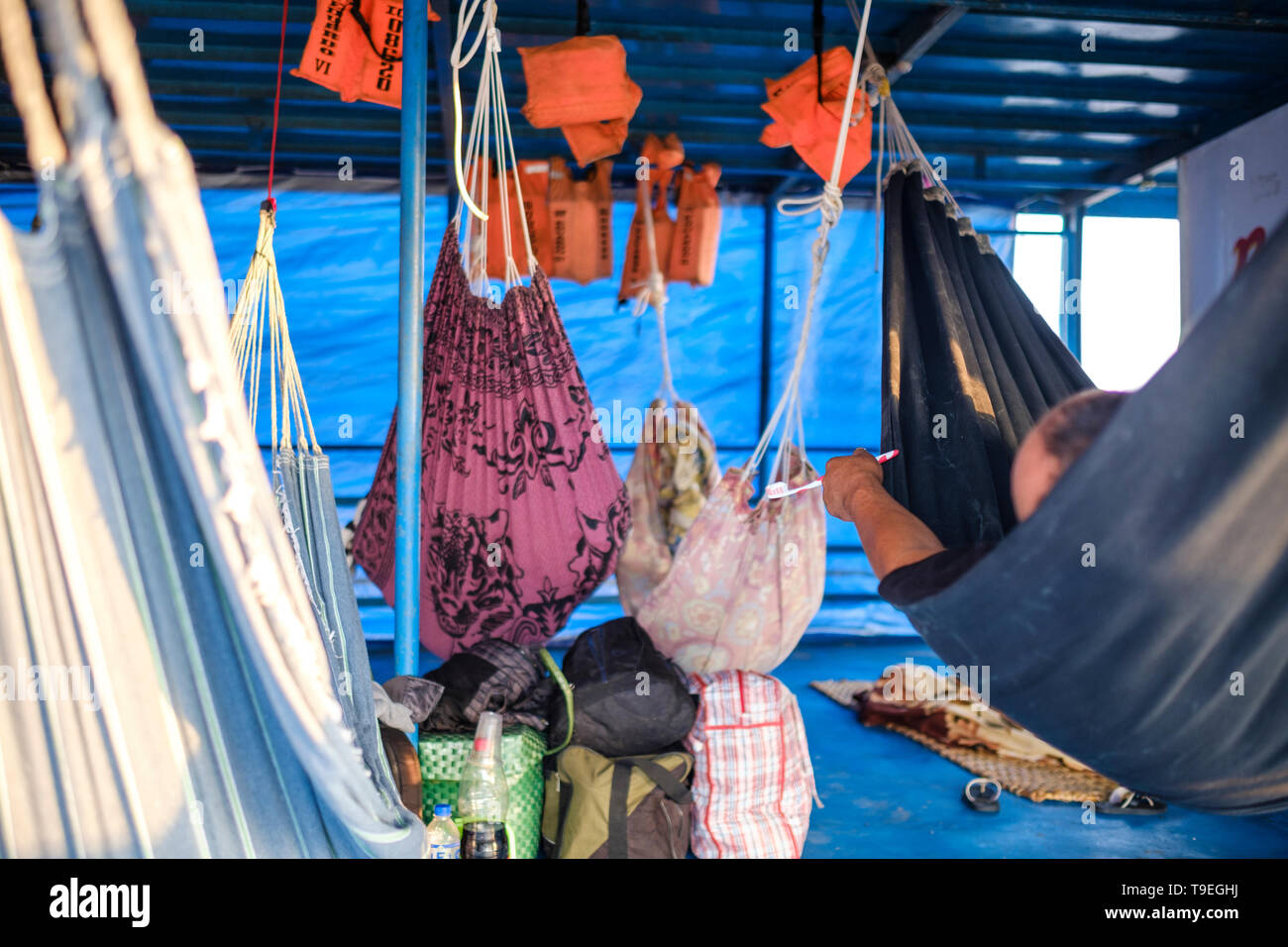 Hammocks for passengers set on the deck of the lancha or ferry that ...