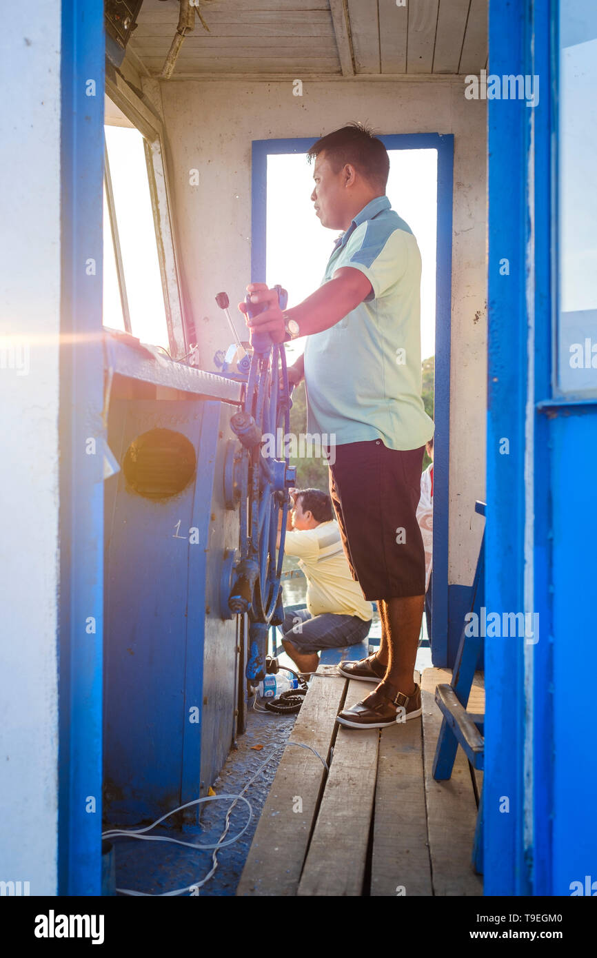 Helmsman in the Eduardo VI ferry cockpit that covers the Yurimaguas ...