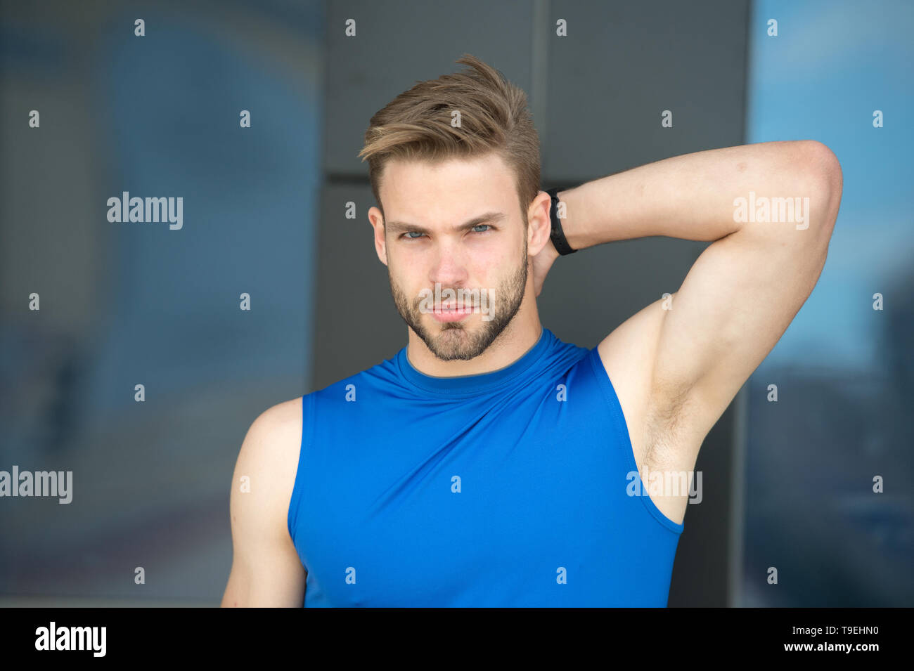 Man confident in his antiperspirant. Sportsman after training pleased ...