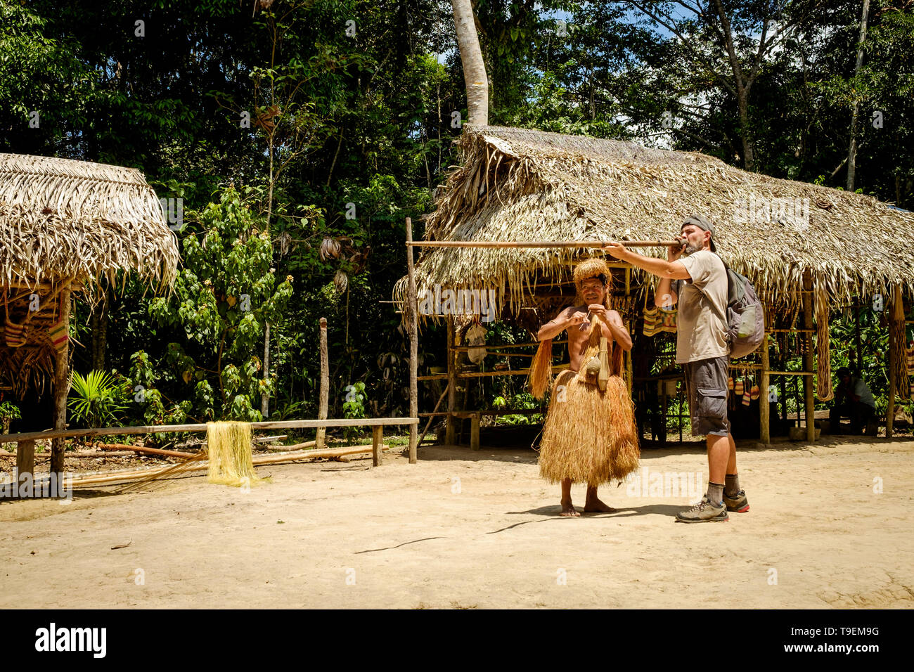 Tourist trying a traditional Yagua tribe blowpipe (or picuna) on the ...