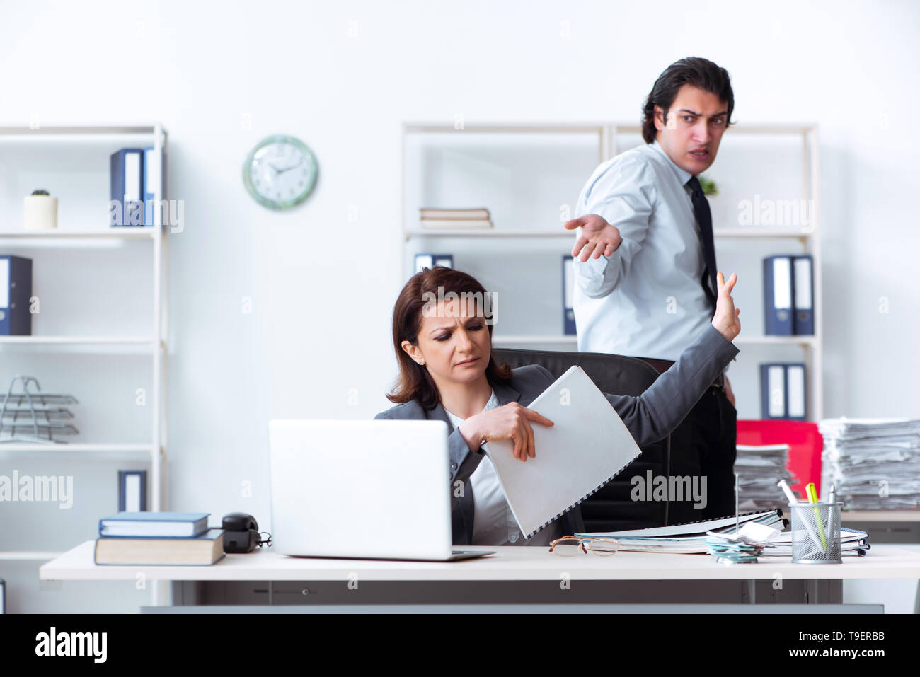 Old female boss and young male employee in the office Stock Photo - Alamy