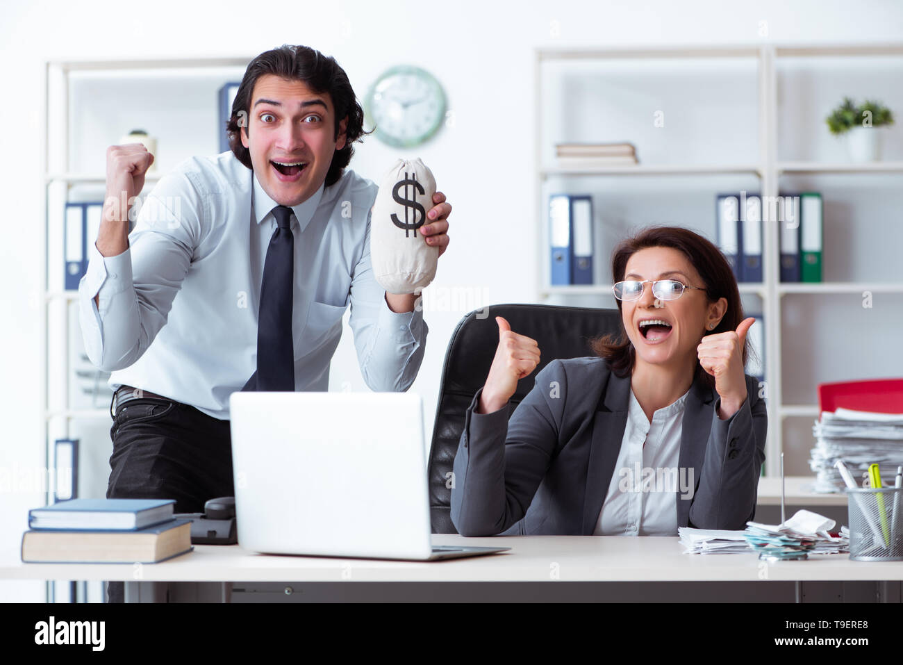 Old female boss and young male employee in the office Stock Photo - Alamy
