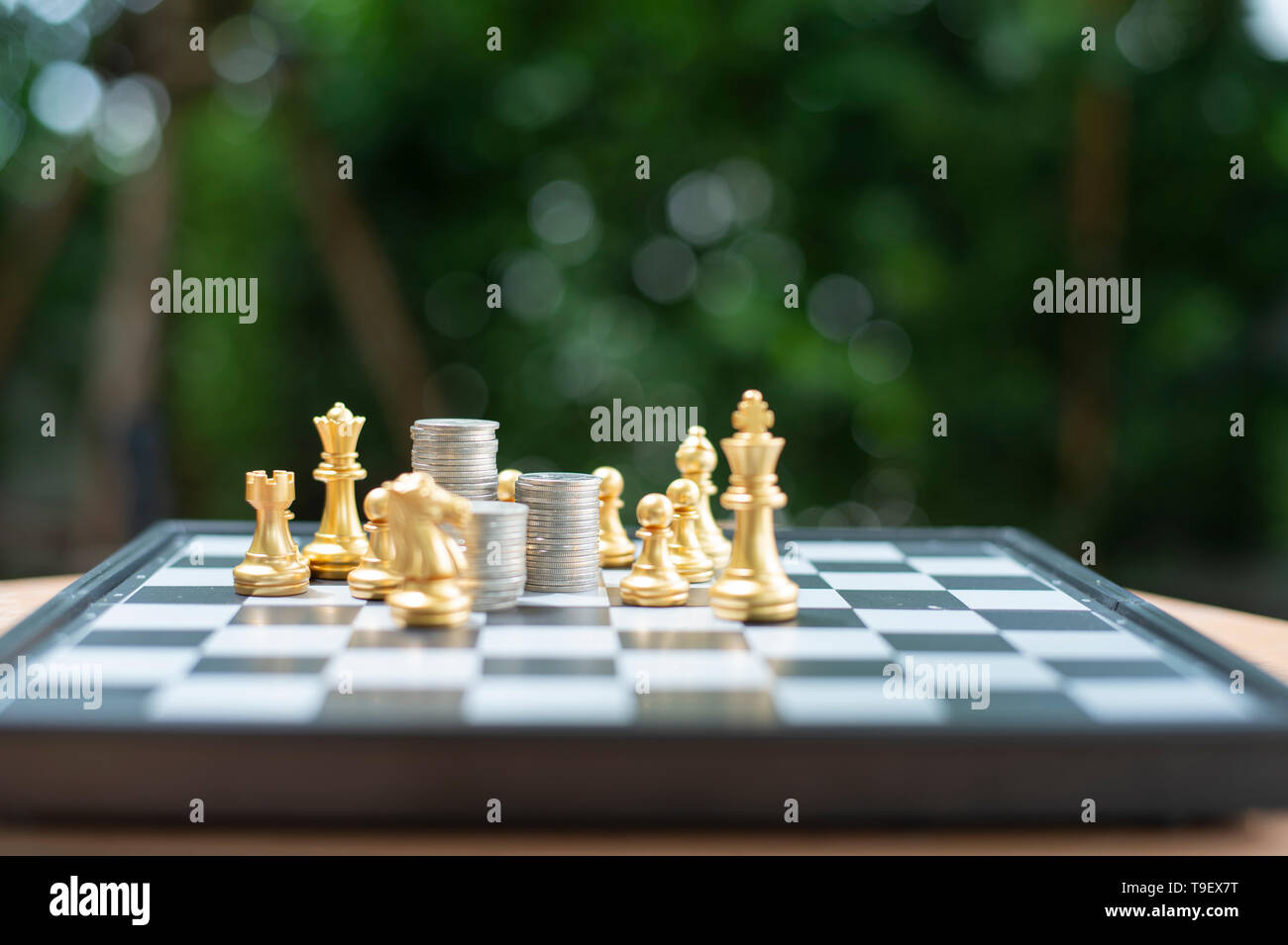 stacked coins on a chess board. conceptual photography on the game in ...