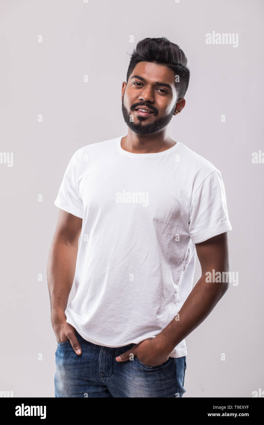 Young indian man standing isolated on white background Stock Photo - Alamy