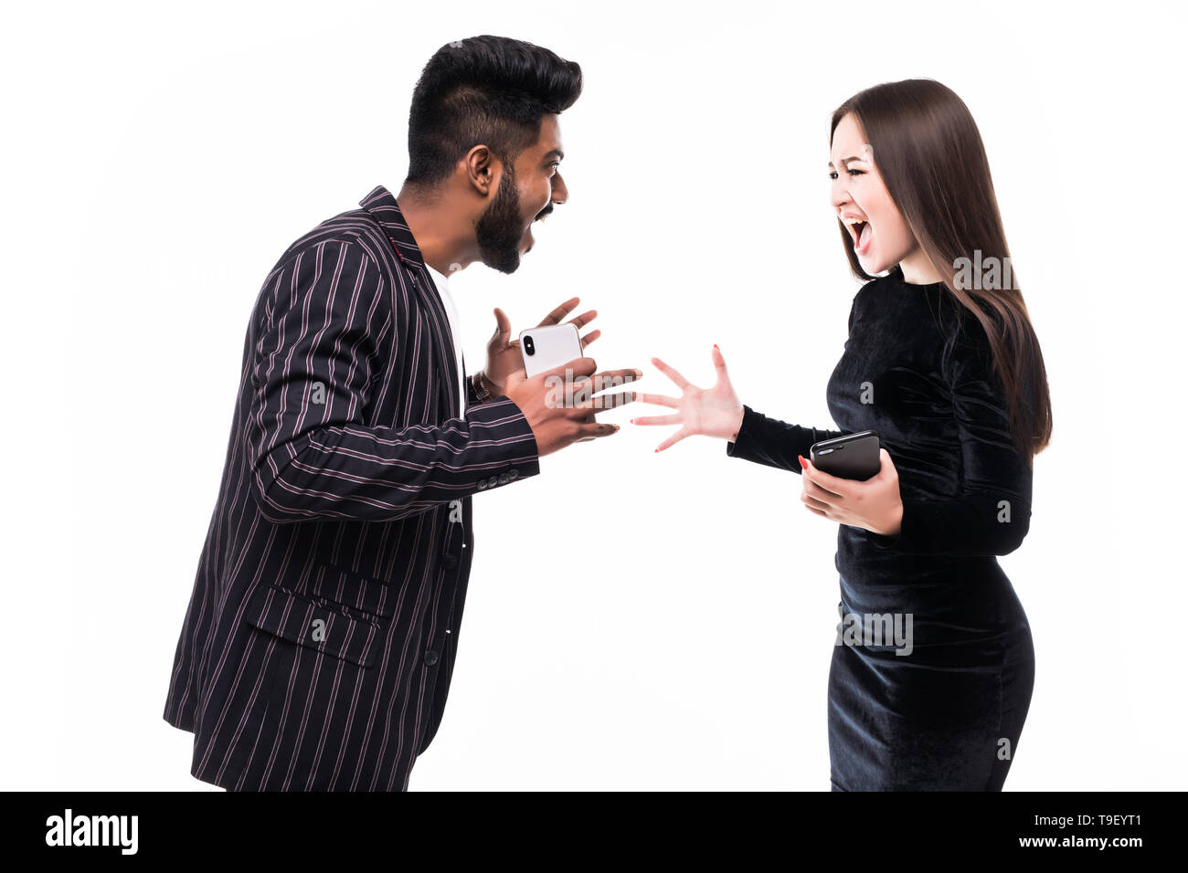 Angry couple shouting at each other on white background Stock Photo - Alamy