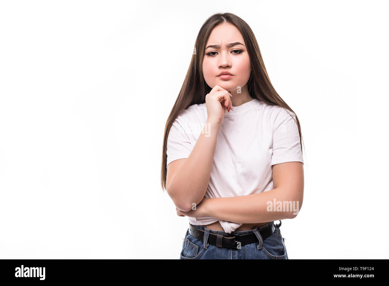 Young sad asian woman with hands on chin isolated on white background ...