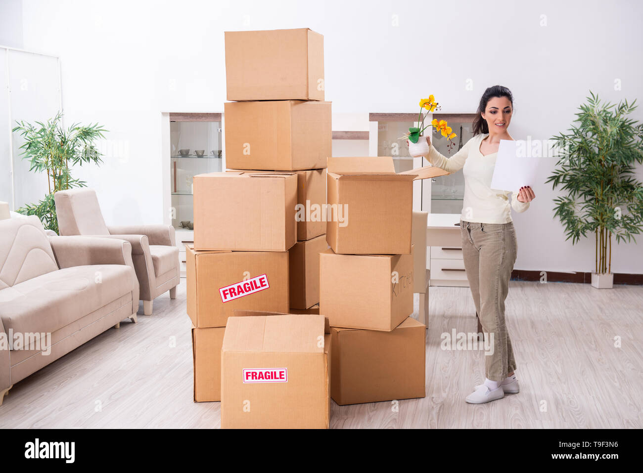 Young woman moving to new flat Stock Photo - Alamy