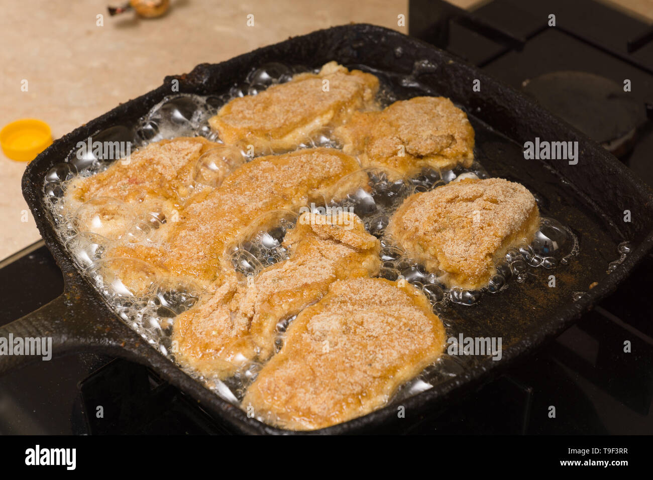cooking nuggets from fresh chicken meat on a hot cast-iron pan Stock ...