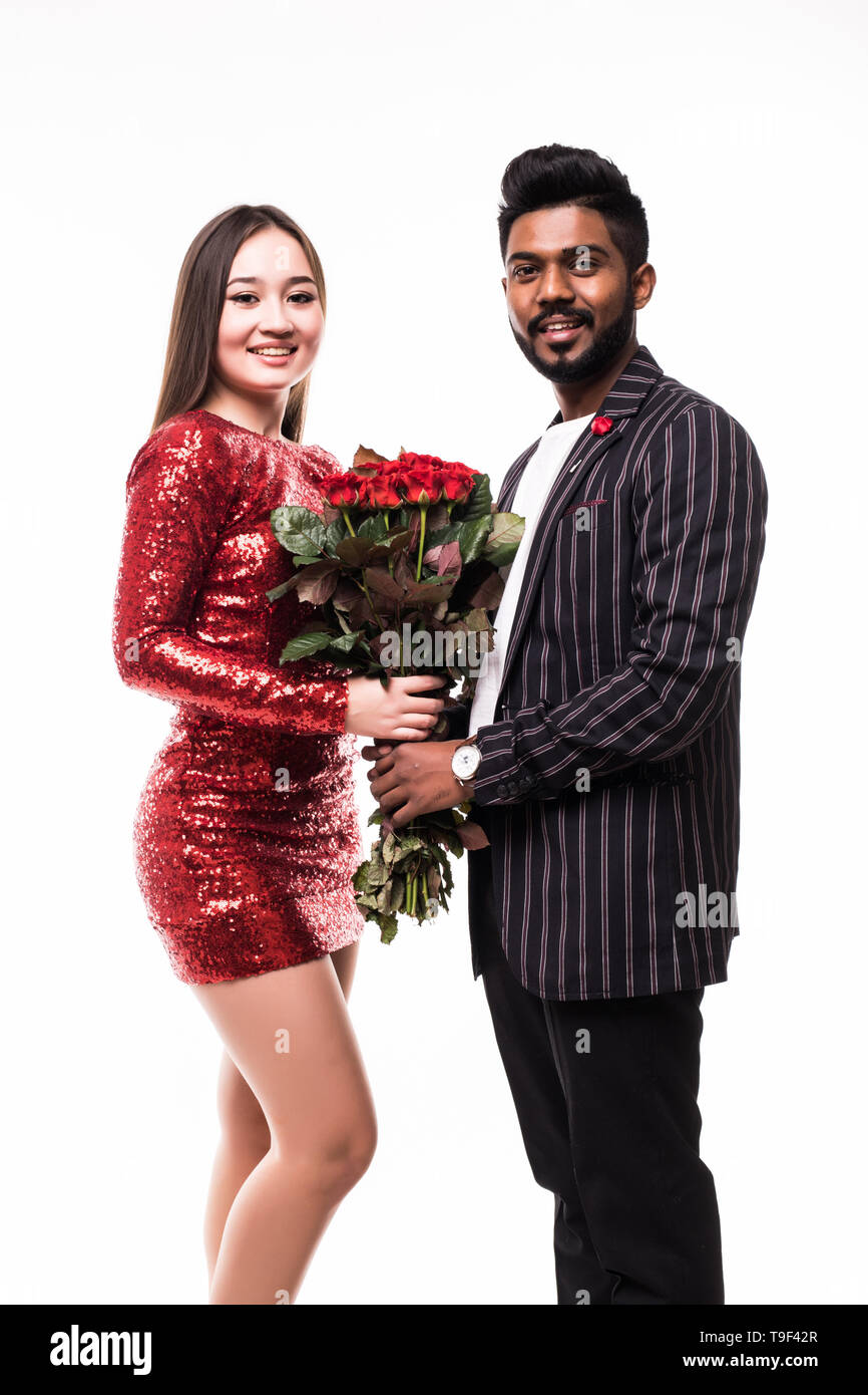 Beautiful elegant couple with big bouquet of red rose on white ...