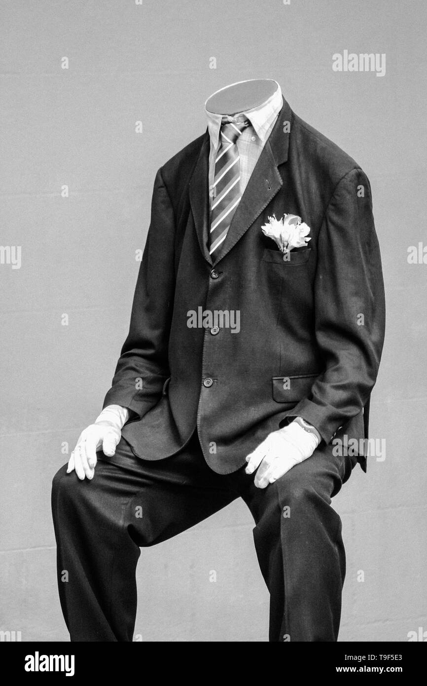 a mime in barcelona in spain, headless, wearing white gloves and ...