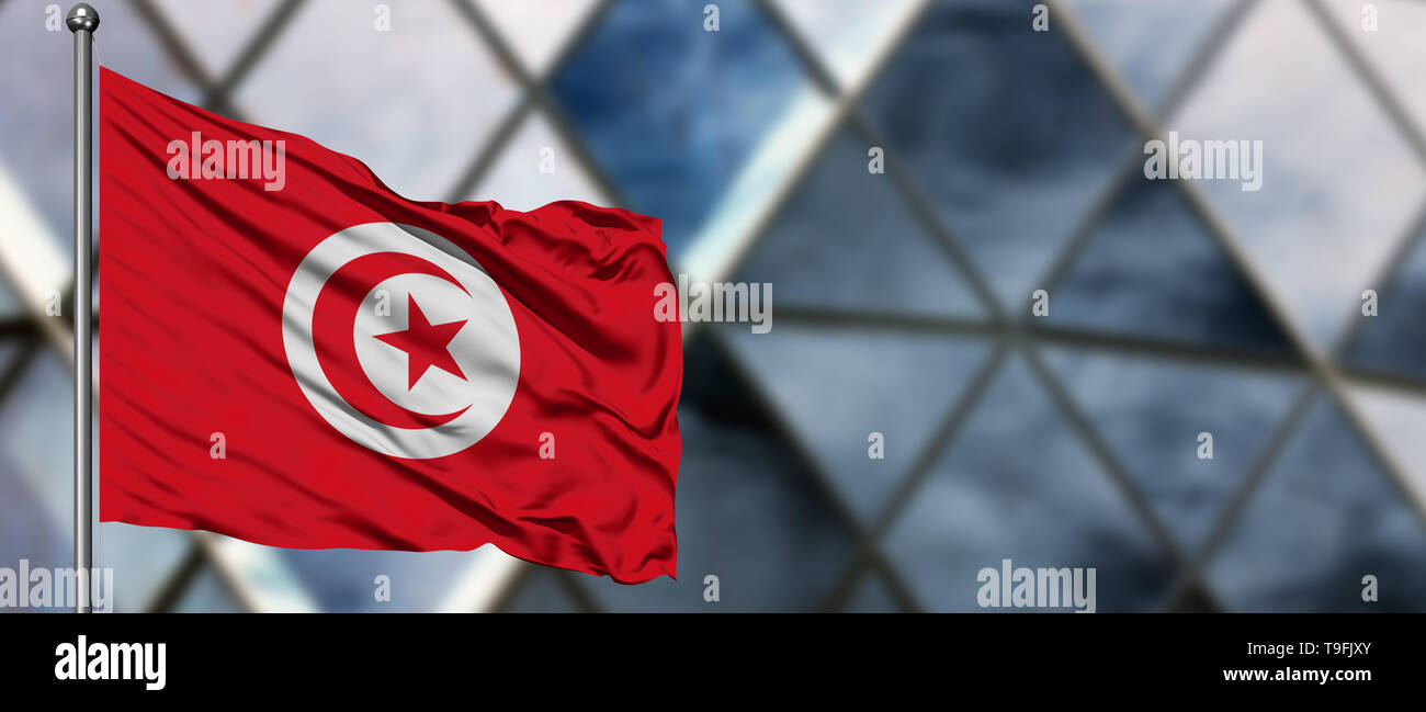 Tunisia flag waving in the wind against blurred modern building ...