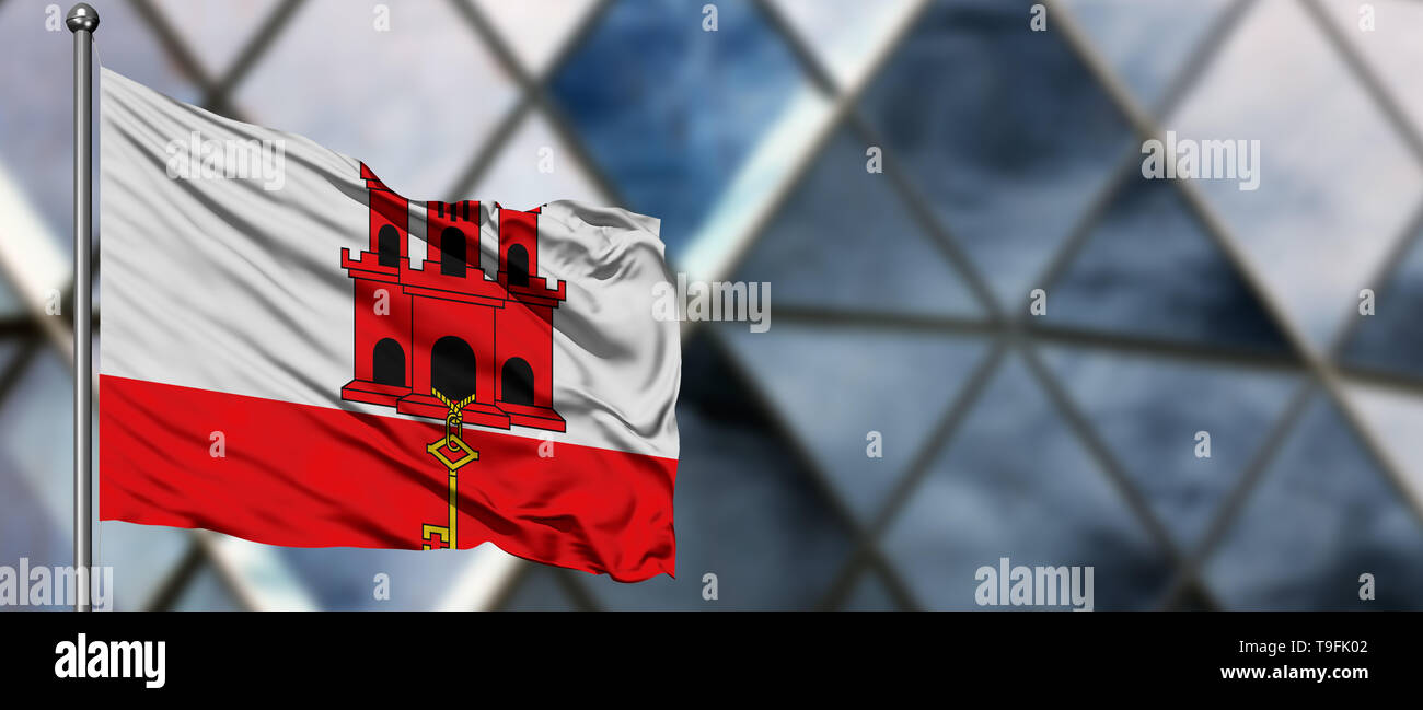 Gibraltar flag waving in the wind against blurred modern building ...
