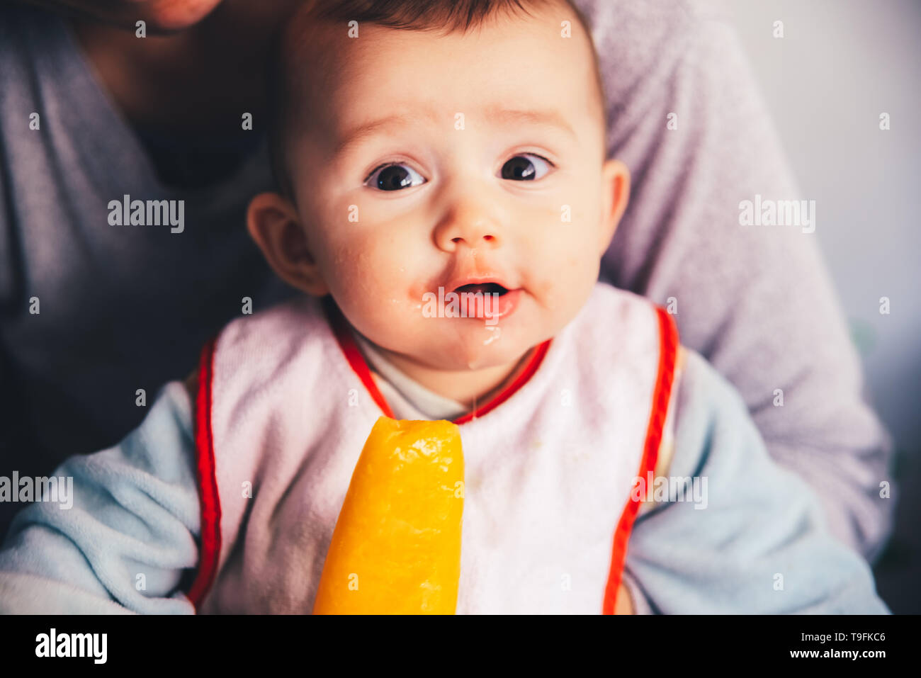 Baby smiling and drooling when trying for the first time an ice cream ...